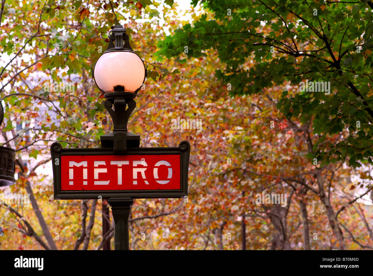 Red metro sign in Paris France on background of fall trees Stock Photo ...