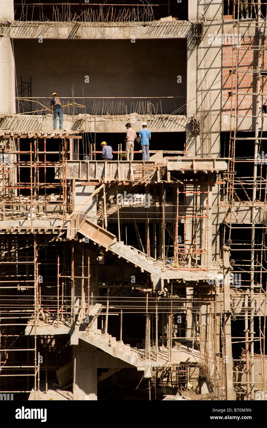 Construction workers work on a building site in the south Indian city ...