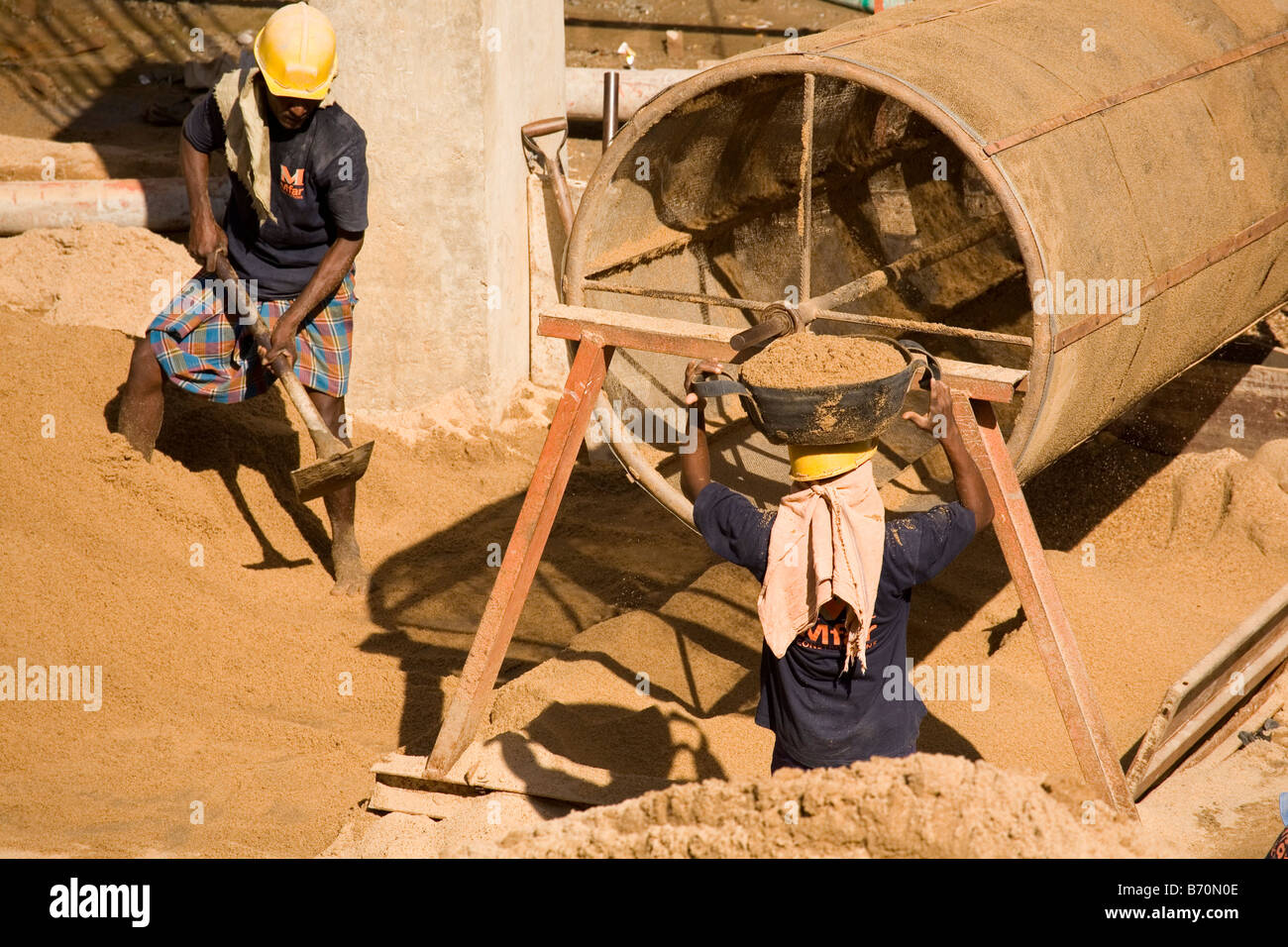 Construction workers work on a building site in the south Indian city ...