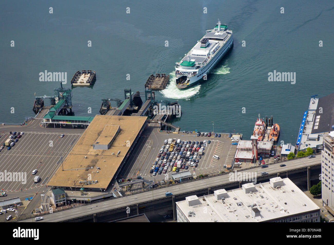 Aerial view of ferry boat entering terminal along waterfront of Seattle ...
