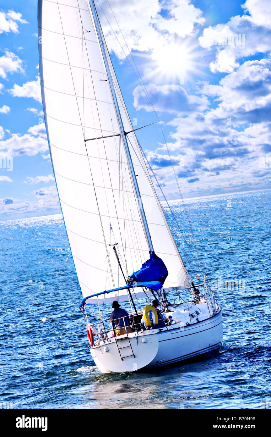 Sailboat with white sail sailing on a sunny day Stock Photo - Alamy