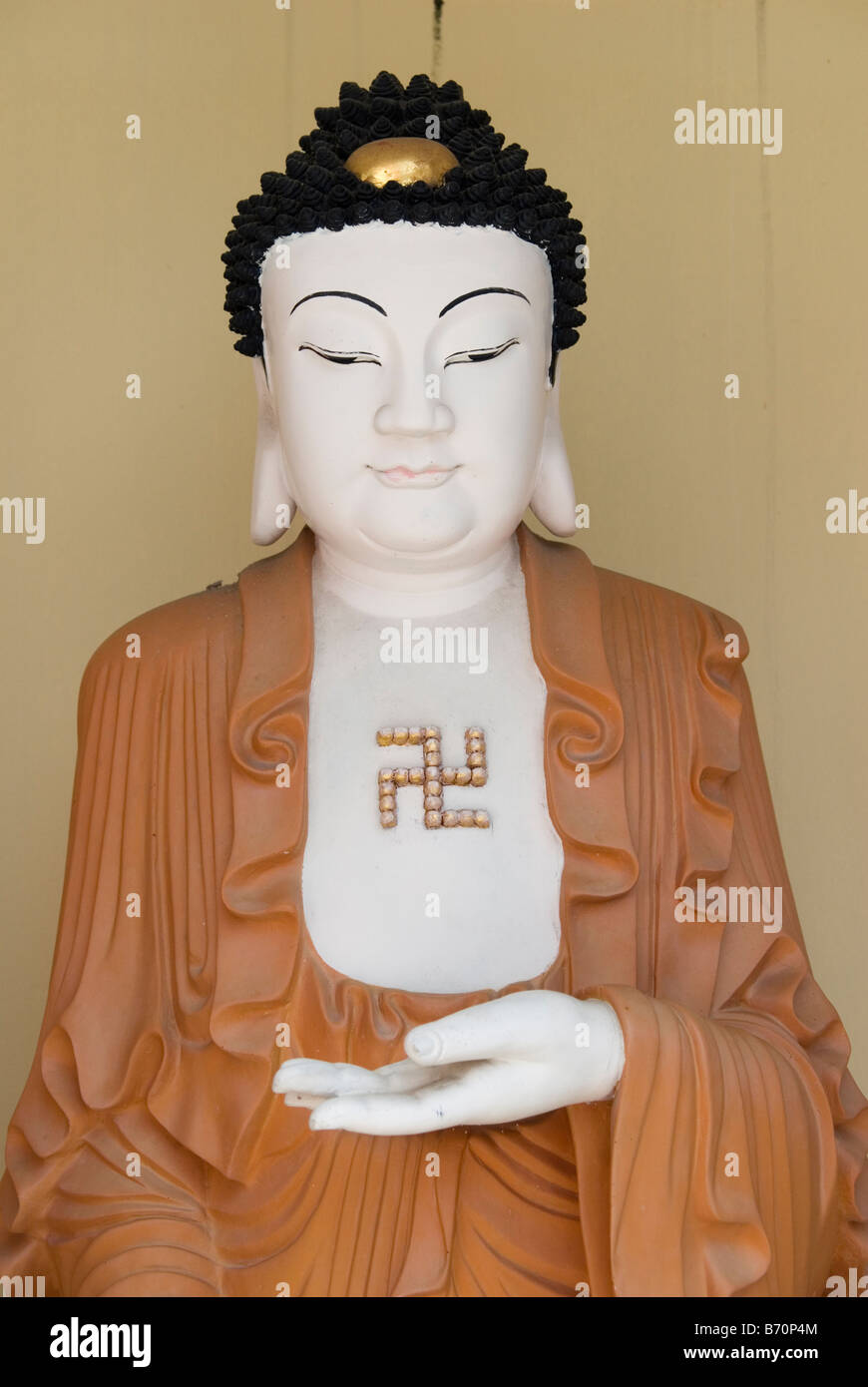 Standing Buddha figure with a left facing swastika on his chest at the ...