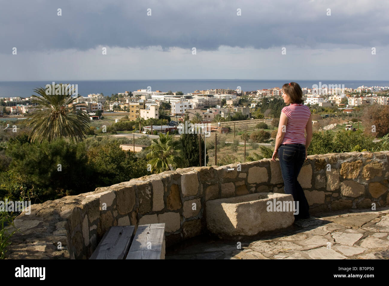 Admiring the View Woman looking out from Stone Balcony in Paphos across ...