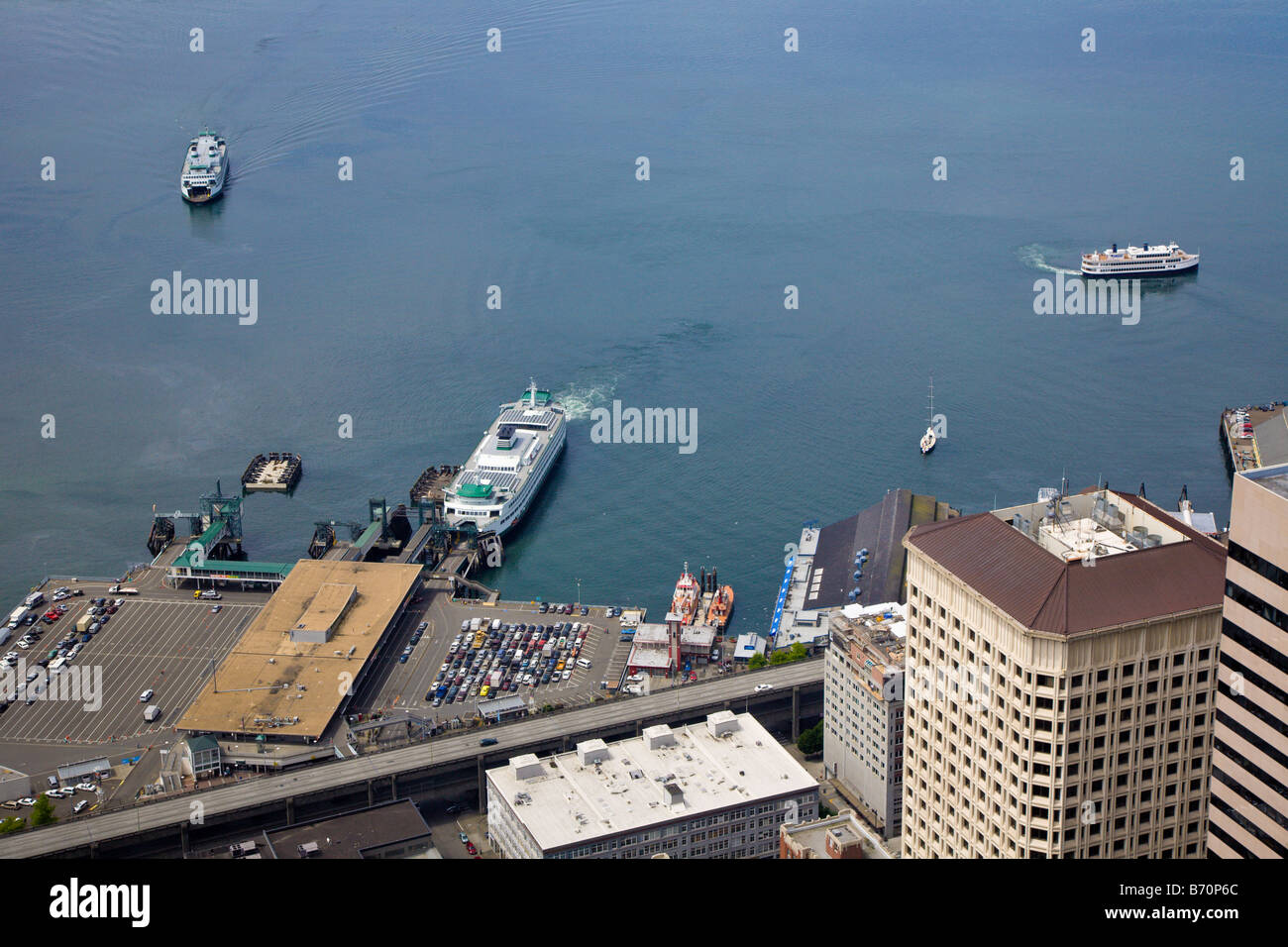 Aerial view of ferry boat entering terminal along waterfront of Seattle ...