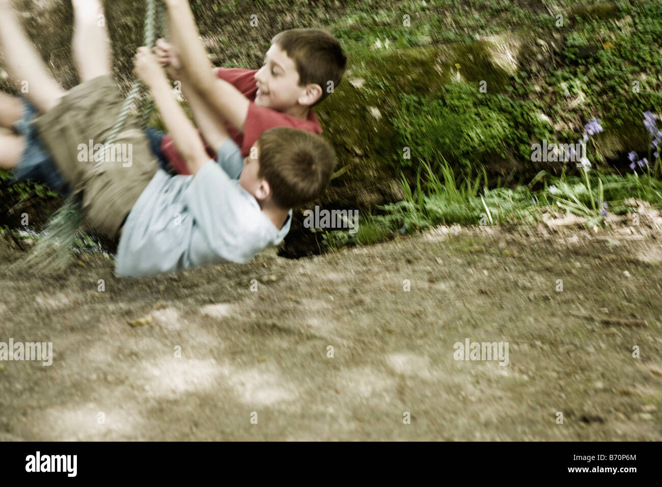 two boys on a rope swing Stock Photo - Alamy