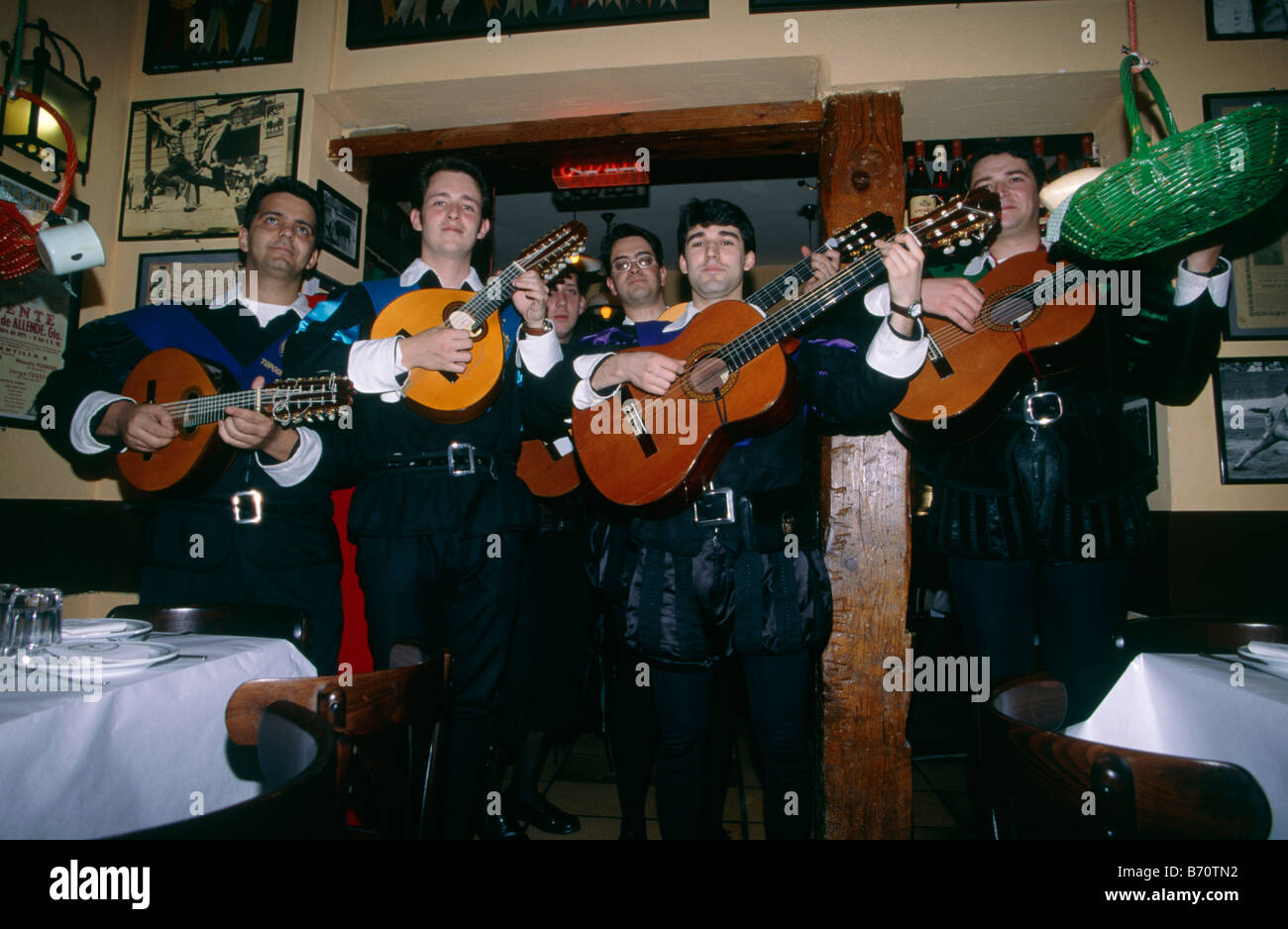 La Tuna Band of men in restaurant in doublet and hose Playing guitars ...
