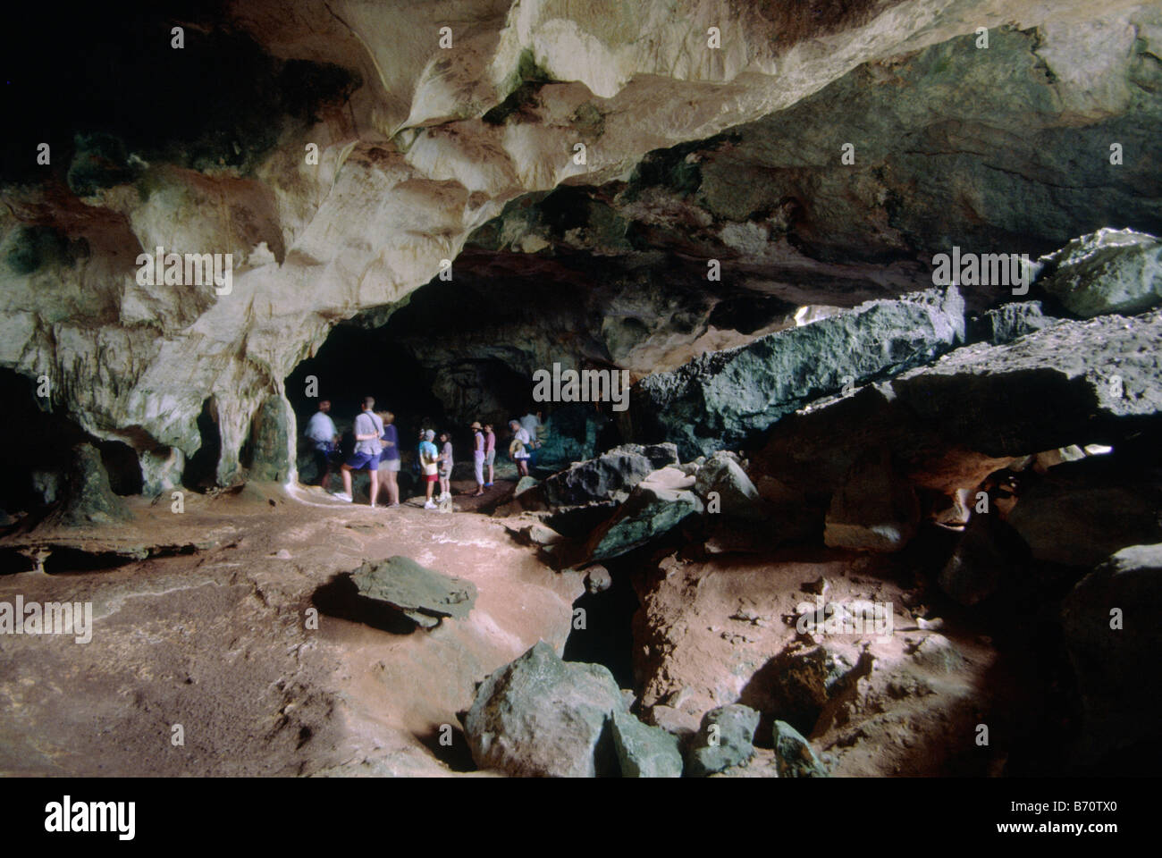 Cliffs Caves erosion by water Large stone blocks People CONCH BAR CAVES ...