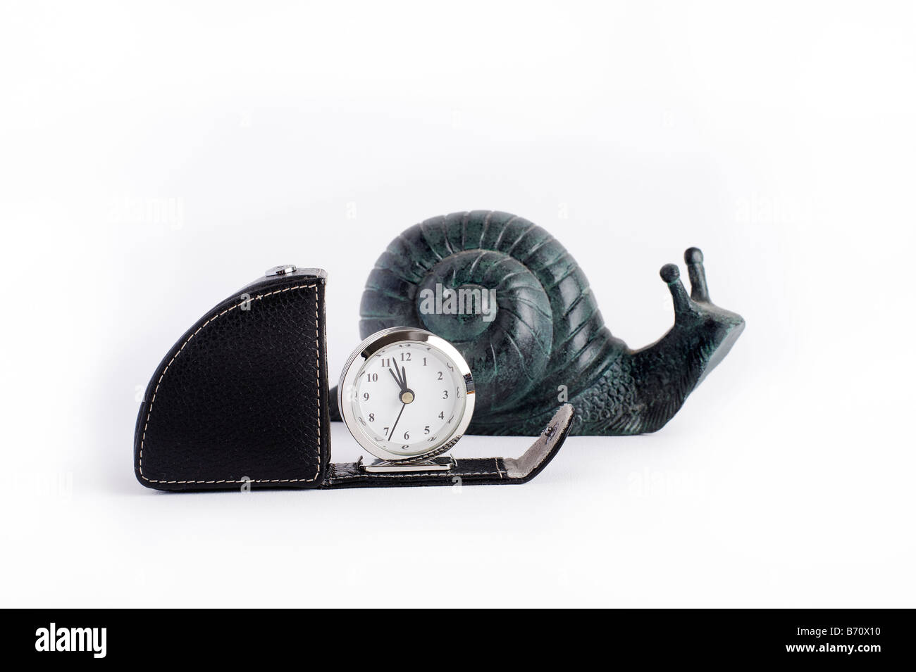 similarly shaped clock and carved snail side by side Stock Photo - Alamy