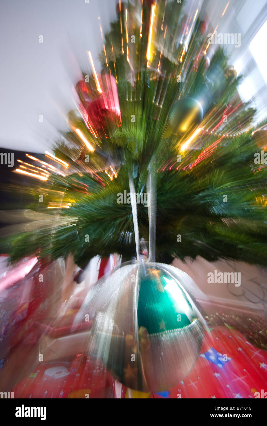 A zoomed photograph of christmas tree, baubles and presents Stock Photo ...