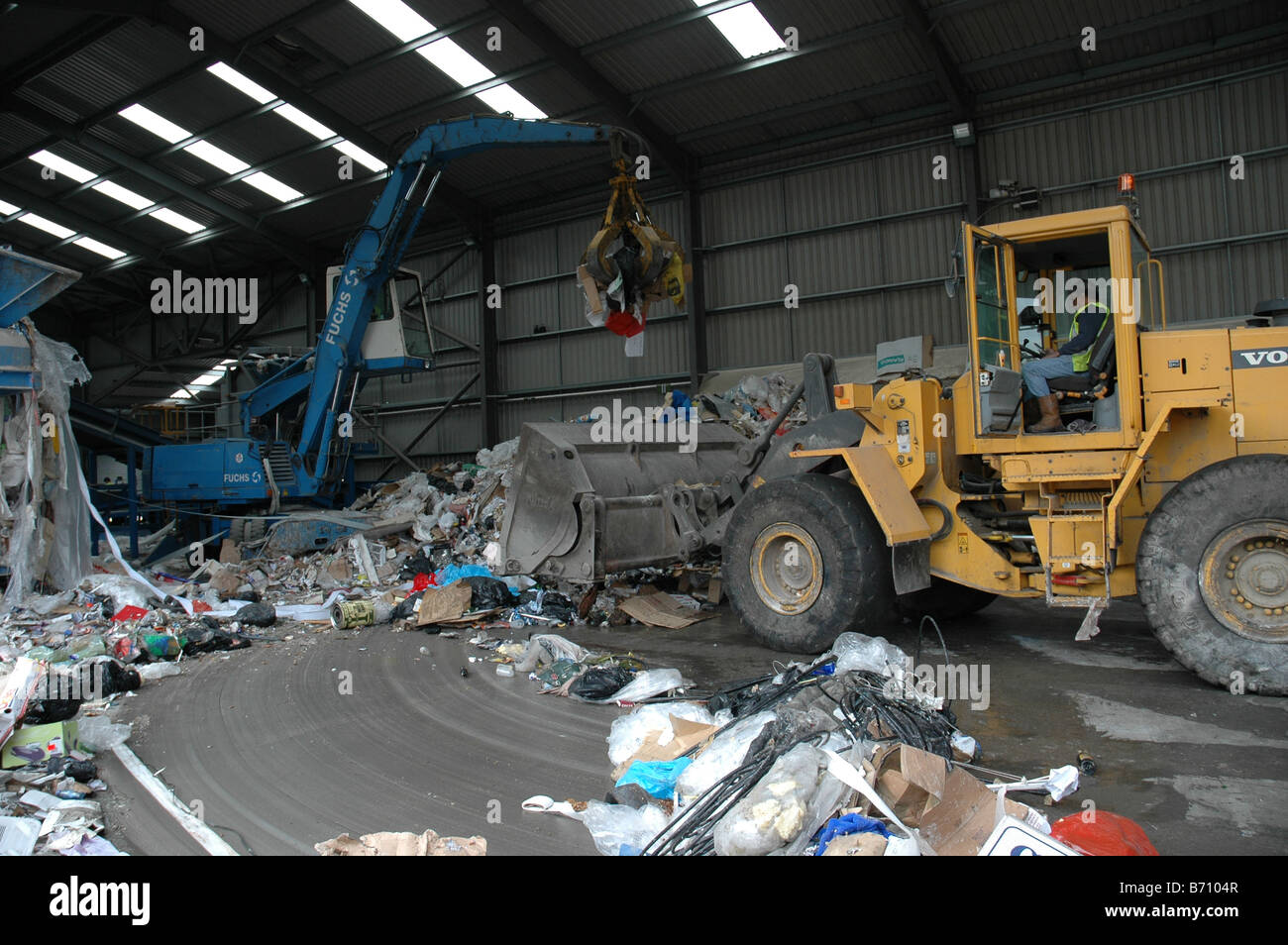 Men at work in a modern recycling centre Stock Photo - Alamy