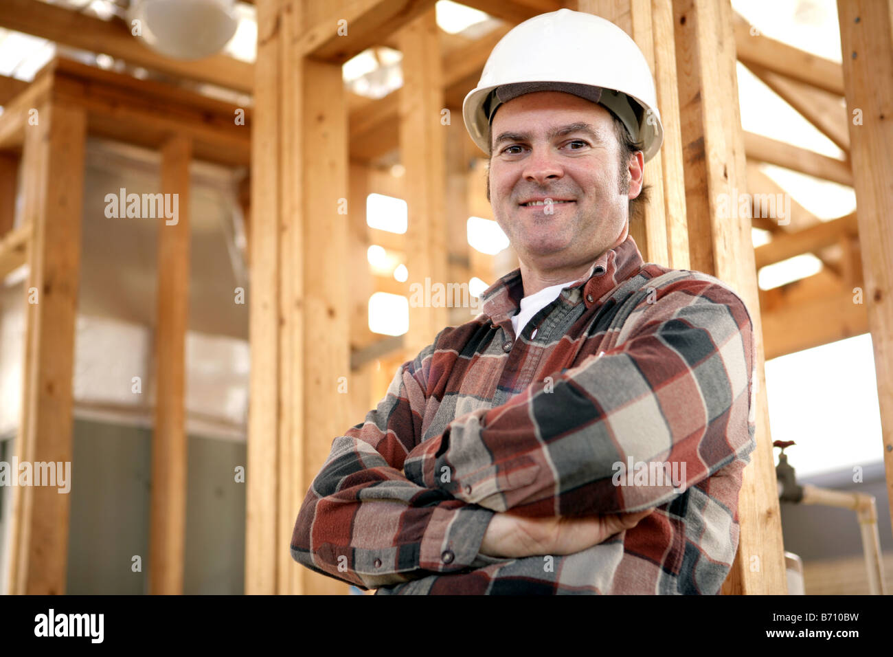 A handsome friendly construction worker on the job site Authentic ...