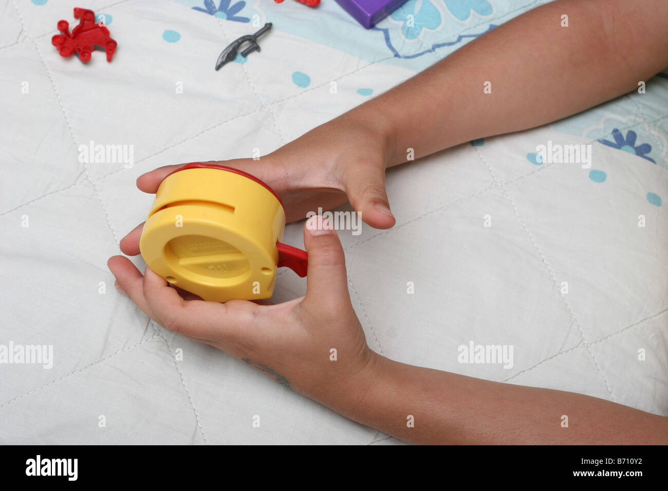 Hands of a young boy playing with toys Stock Photo - Alamy