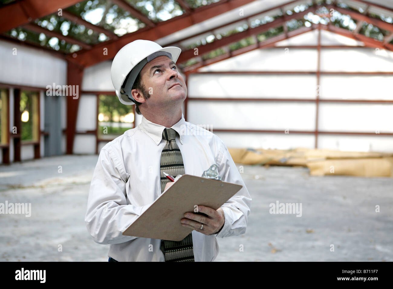 A building inspector examining the the steel girders in a building ...