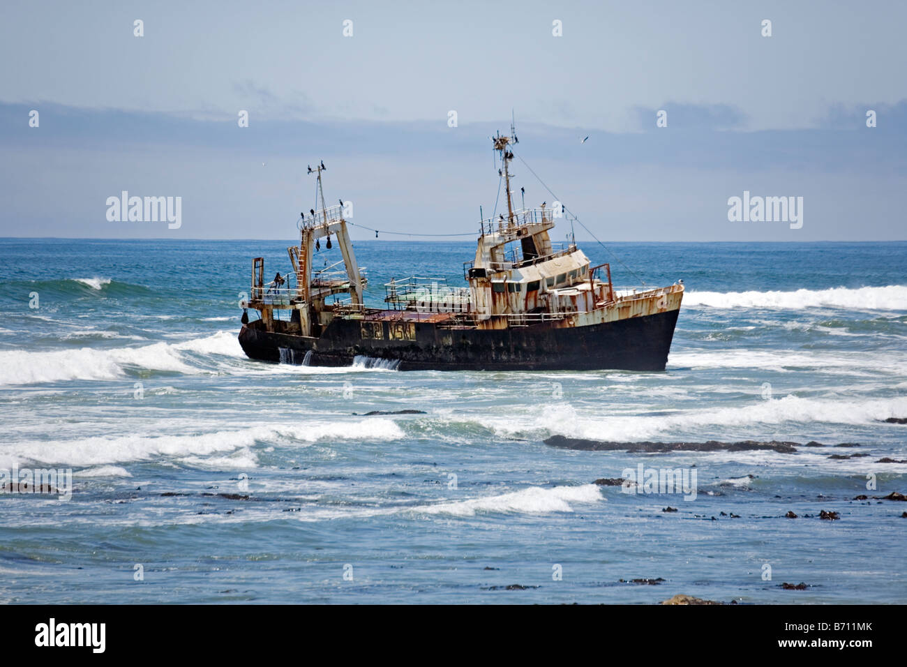 Rusting ship hull along Atlantic ocean coastline at Walvis Bay West ...