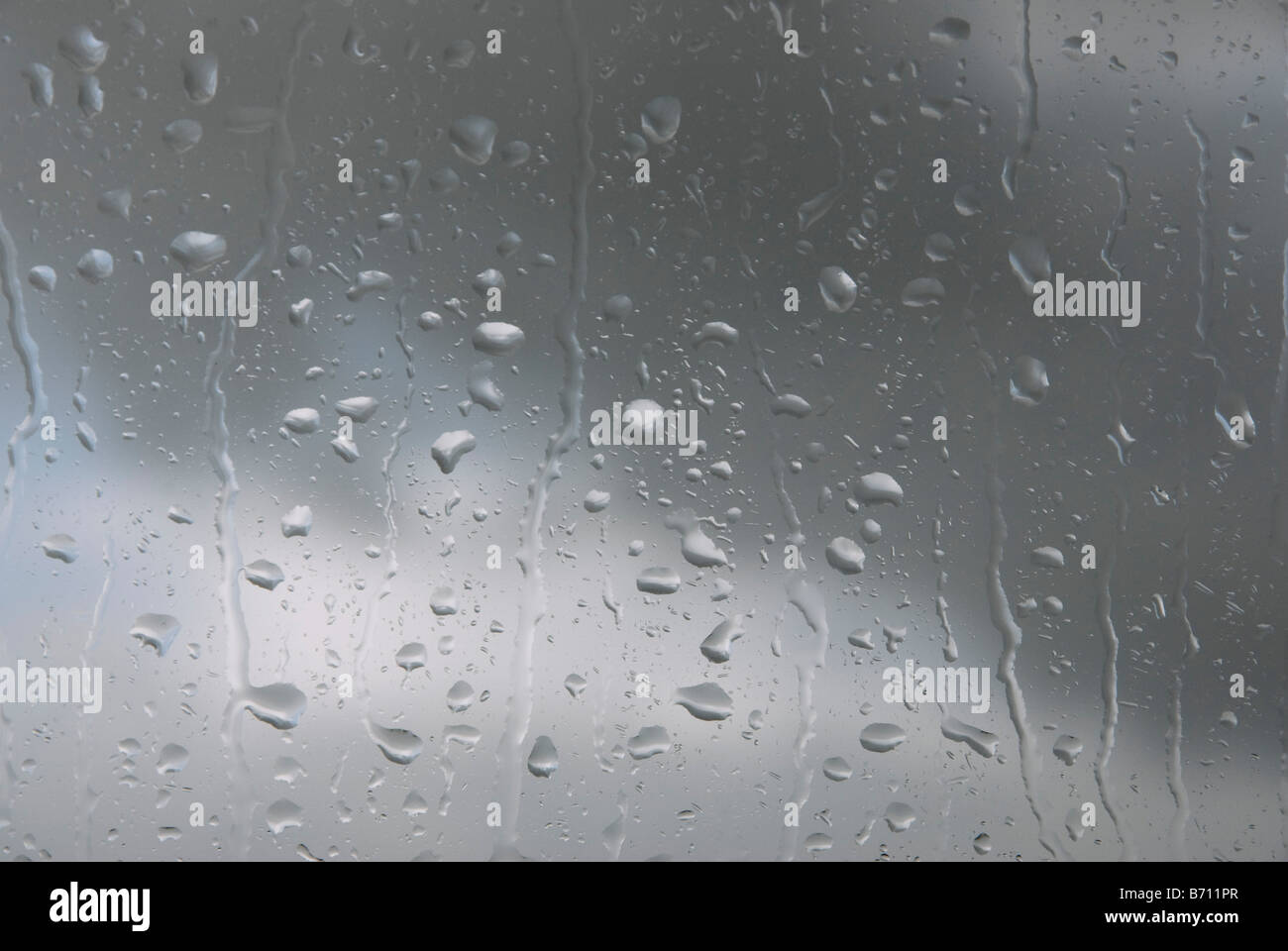 Water droplets on a window with storm clouds behind Stock Photo - Alamy