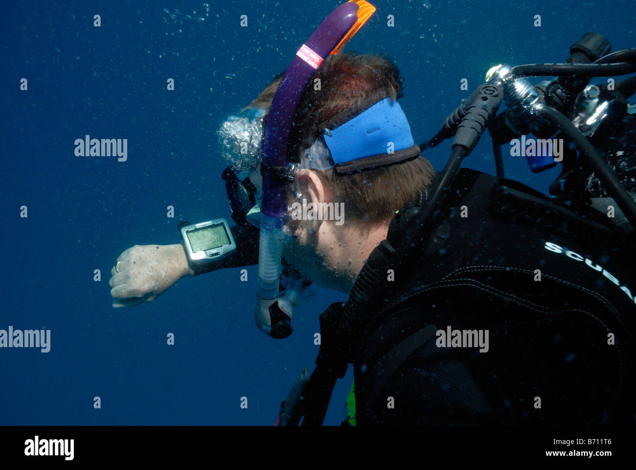 Scuba diver checking decompression computer Mahe Seychelles Stock Photo ...