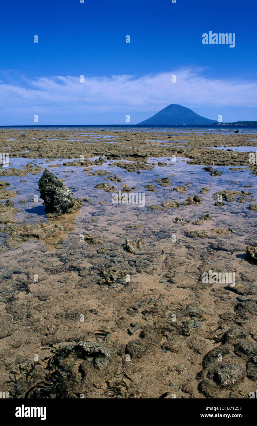 Reef at low tide with Manado Tua volcano island in background, Manado ...