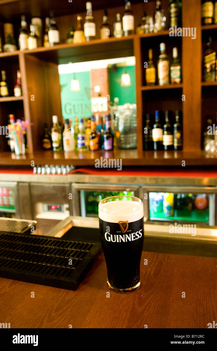 A glass of Guinness beer served in an Irish pub Stock Photo - Alamy