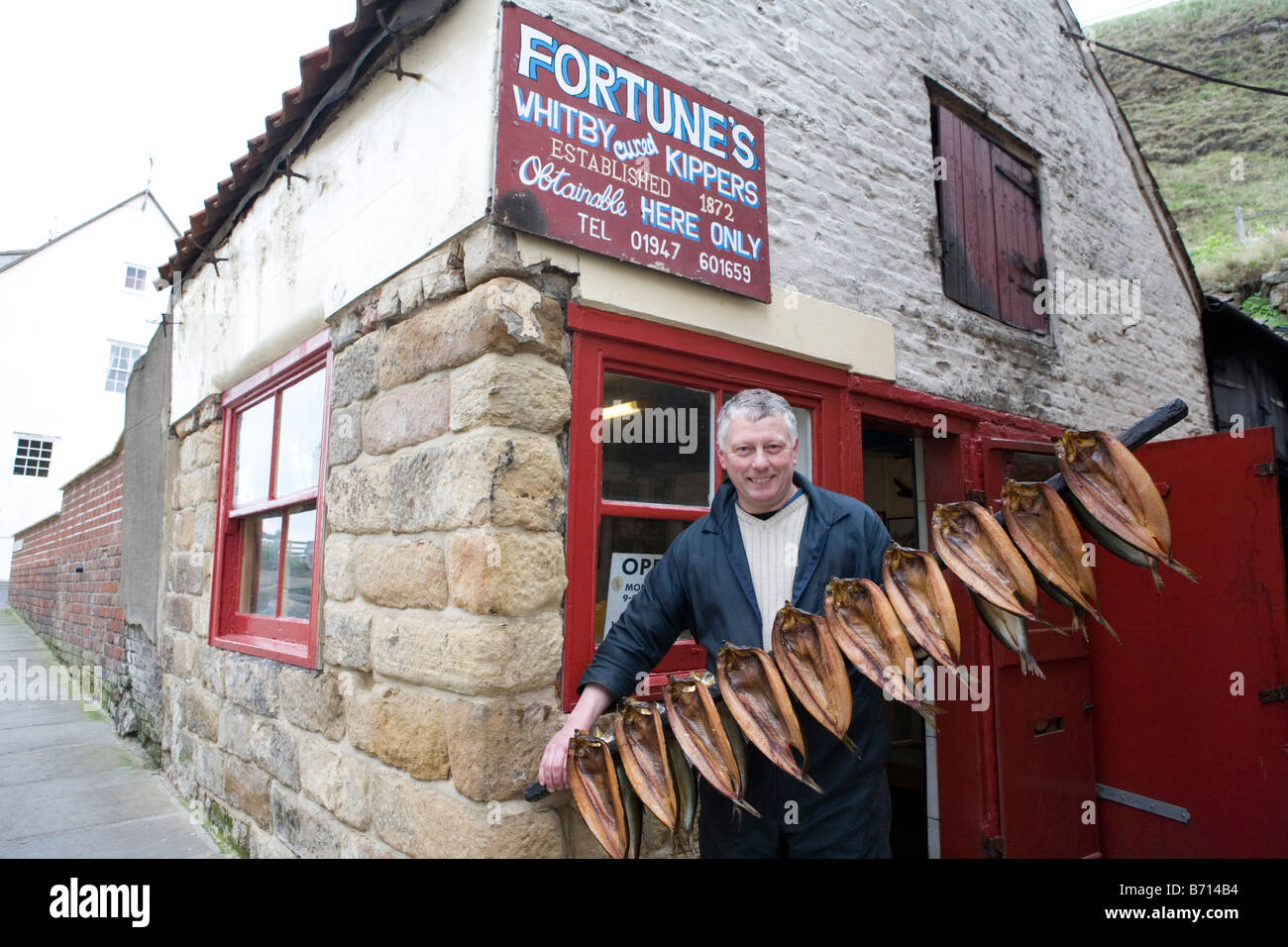 Derek Brown holding smoked herrings in front of the family kippers ...
