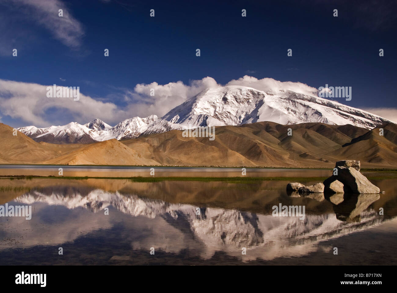 Mirror reflection of Mustagata on the Karakul lake Xinjiang China Stock ...