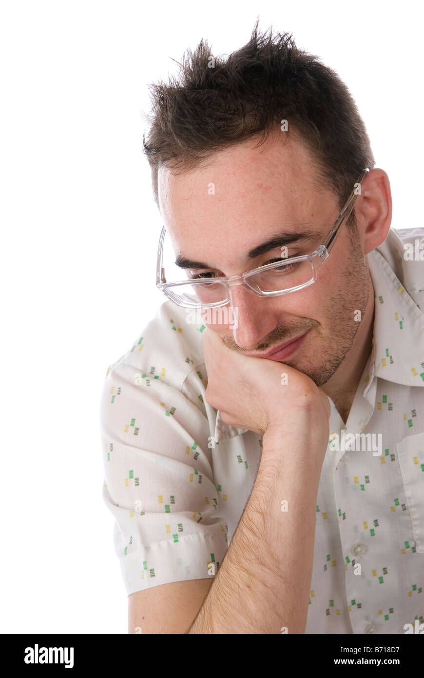 Young man leaning on elbow, looking down and somewhat pensive Stock ...