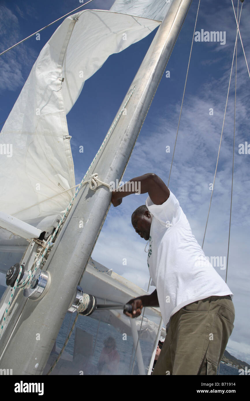 Sailor hoisting a sail on a yacht Stock Photo - Alamy
