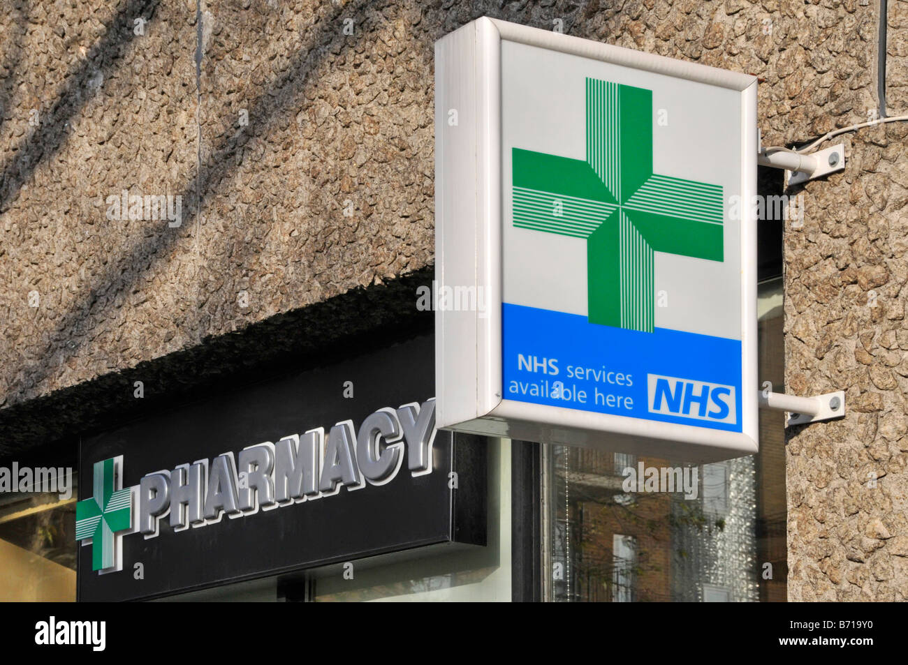 Green cross sign outside chemist pharmacy store above shop front with ...