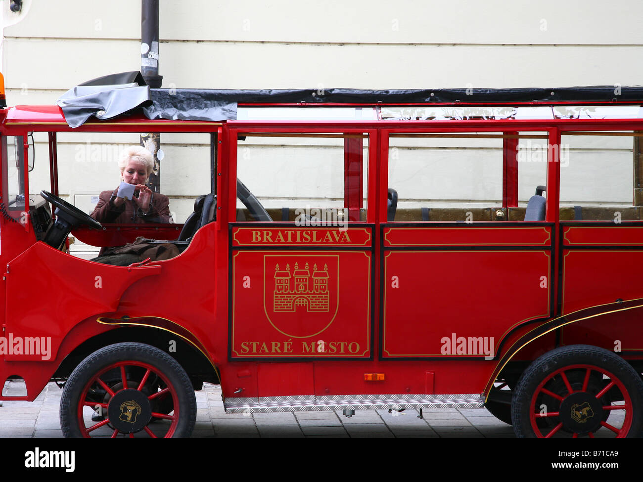 Street scene in Bratislava, Slovakia , woman and tourist bus in central ...