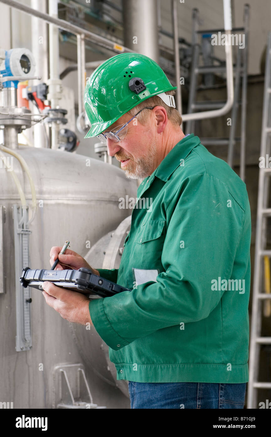 Middle aged industrial worker with notebook Stock Photo - Alamy