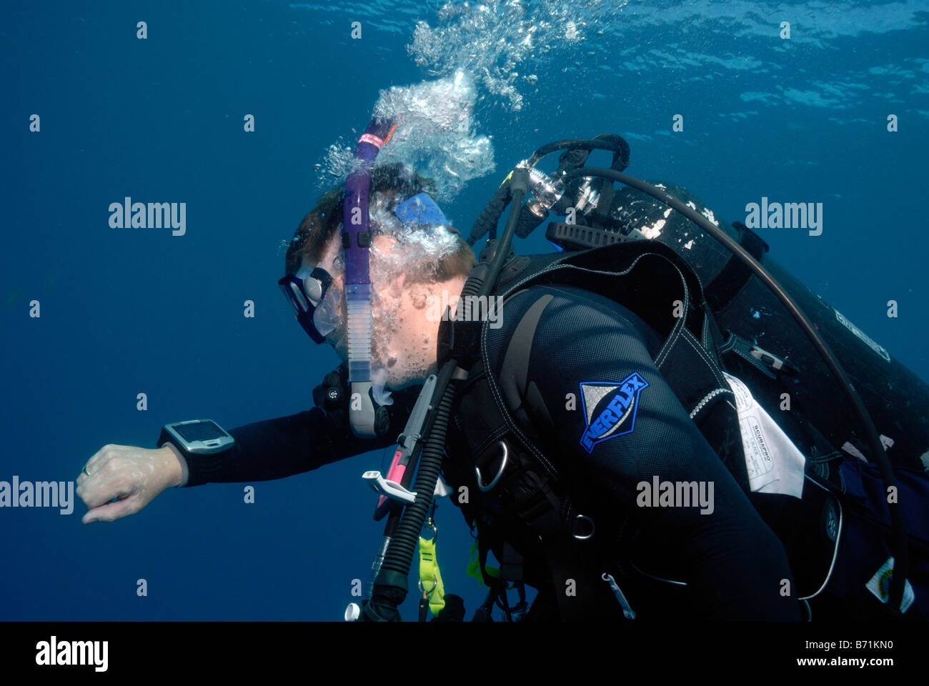 Scuba diver checking decompression computer Mahe Seychelles Stock Photo ...