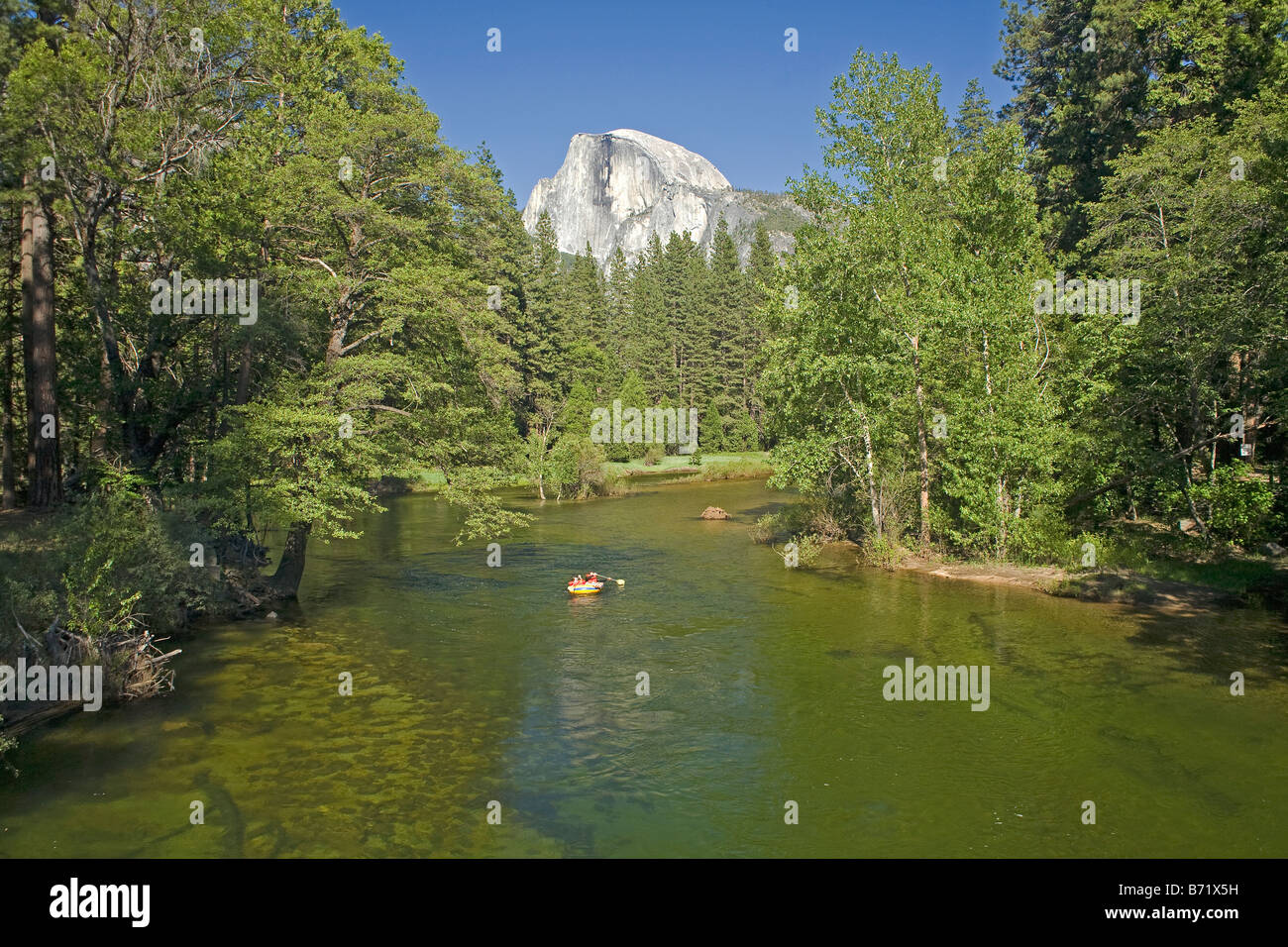 CALIFORNIA - Half Dome towering over the rafters floating down the ...