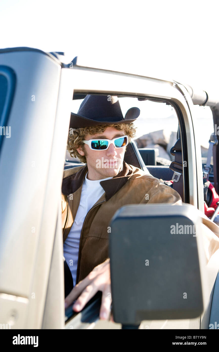 Young man in drivers seat of jeep Stock Photo - Alamy