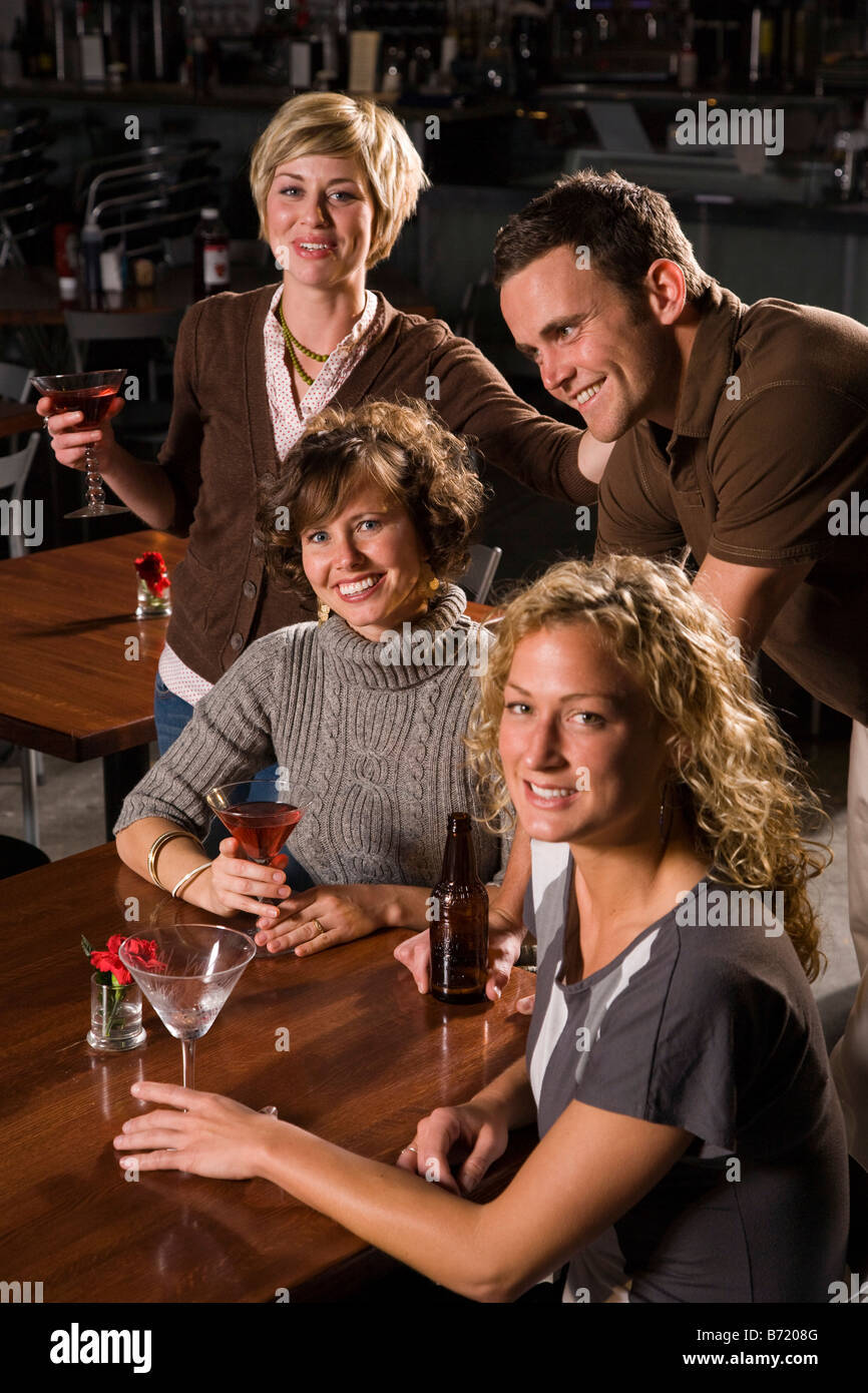 Young friends hanging out and drinking at bar together Stock Photo - Alamy