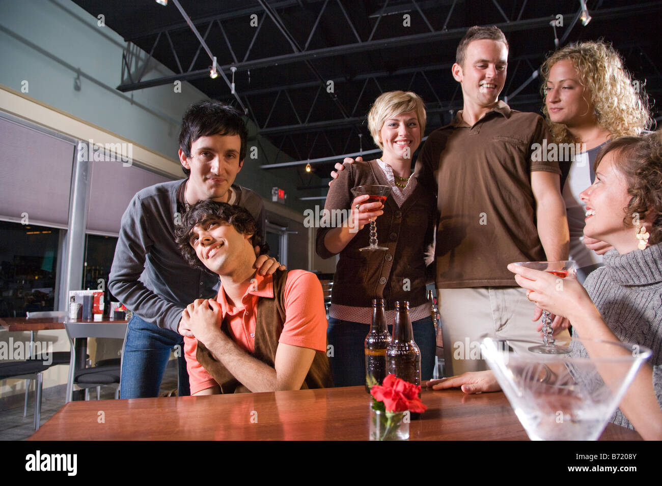 Young friends hanging out and drinking at bar together Stock Photo - Alamy