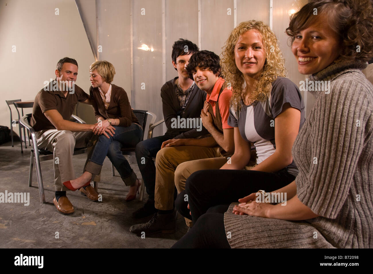 Group of friends sitting together Stock Photo - Alamy