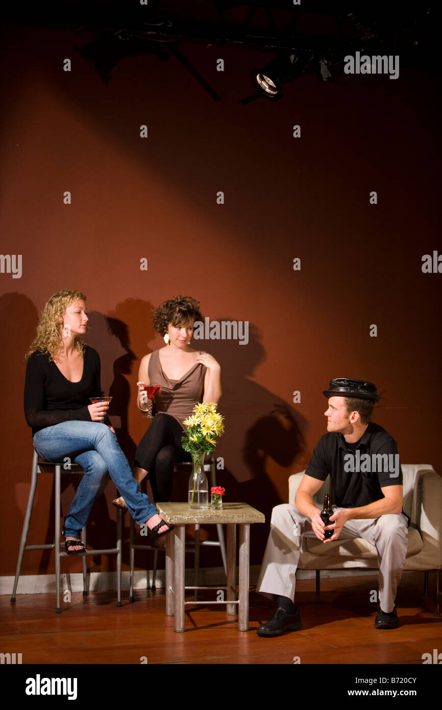Three young adults hanging out and having drinks in modern lounge Stock ...