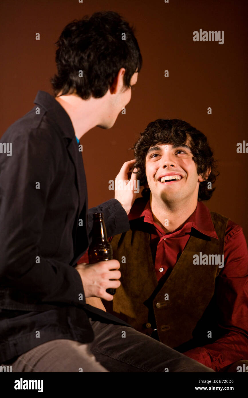Close-up of young male couple gazing with affection at one another ...
