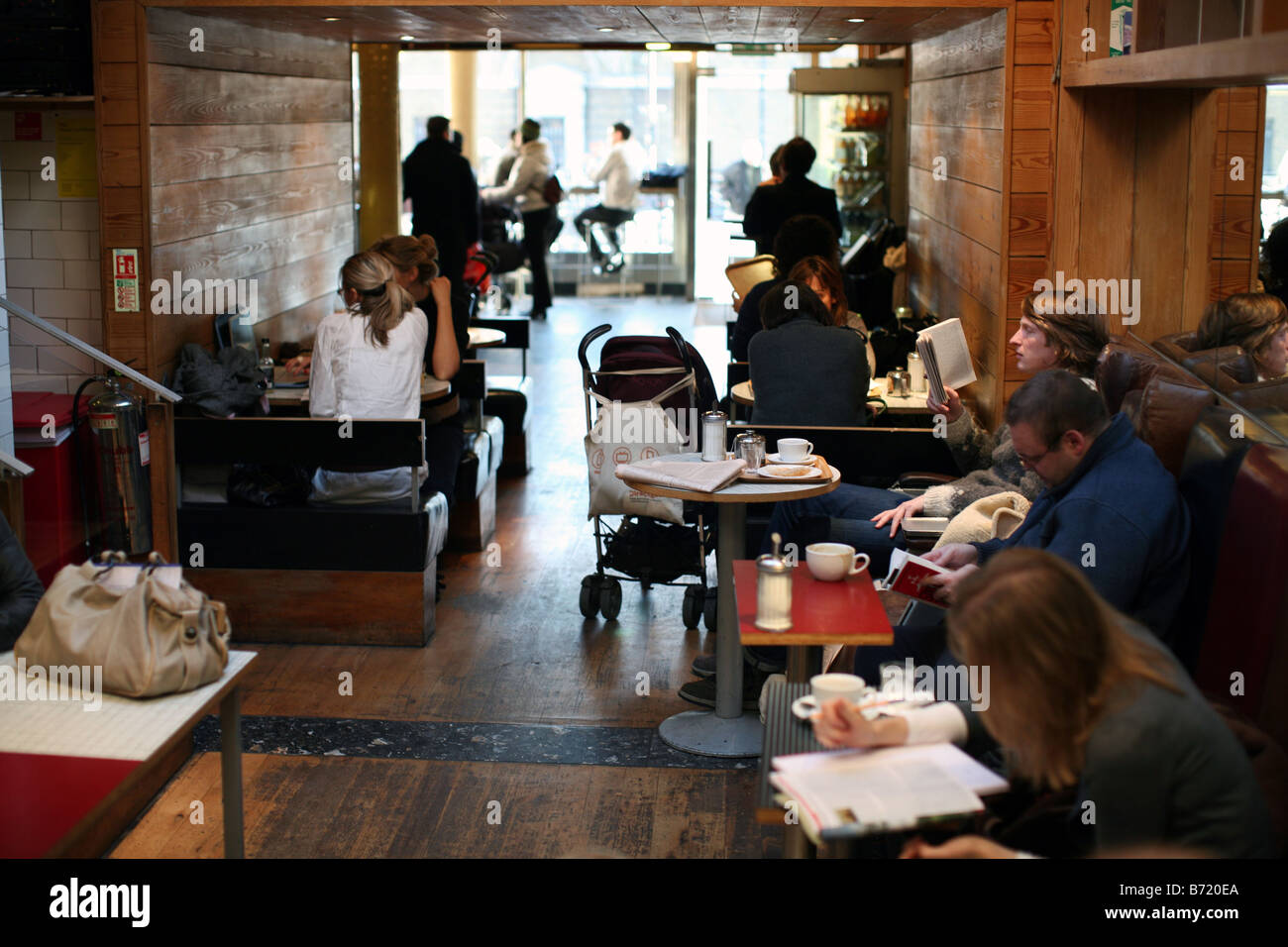 People reading in coffee bar, Islington, London Stock Photo - Alamy