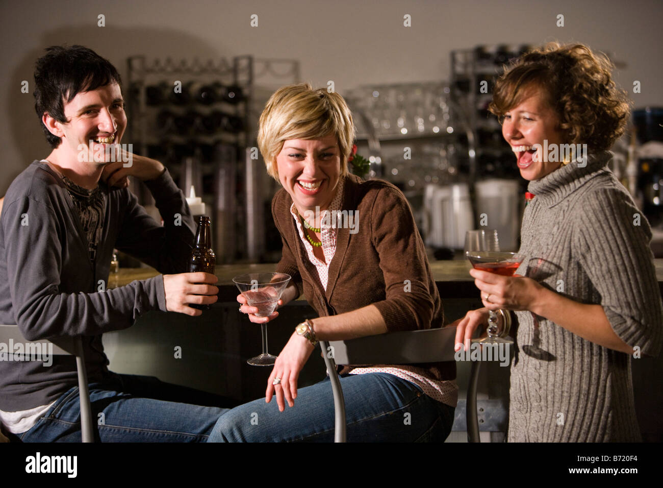 Young friends hanging out and at bar together Stock Photo - Alamy