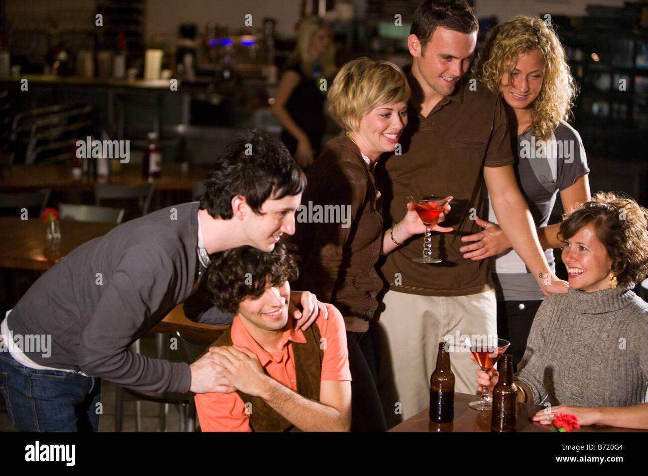 Young friends hanging out and drinking at bar together Stock Photo - Alamy