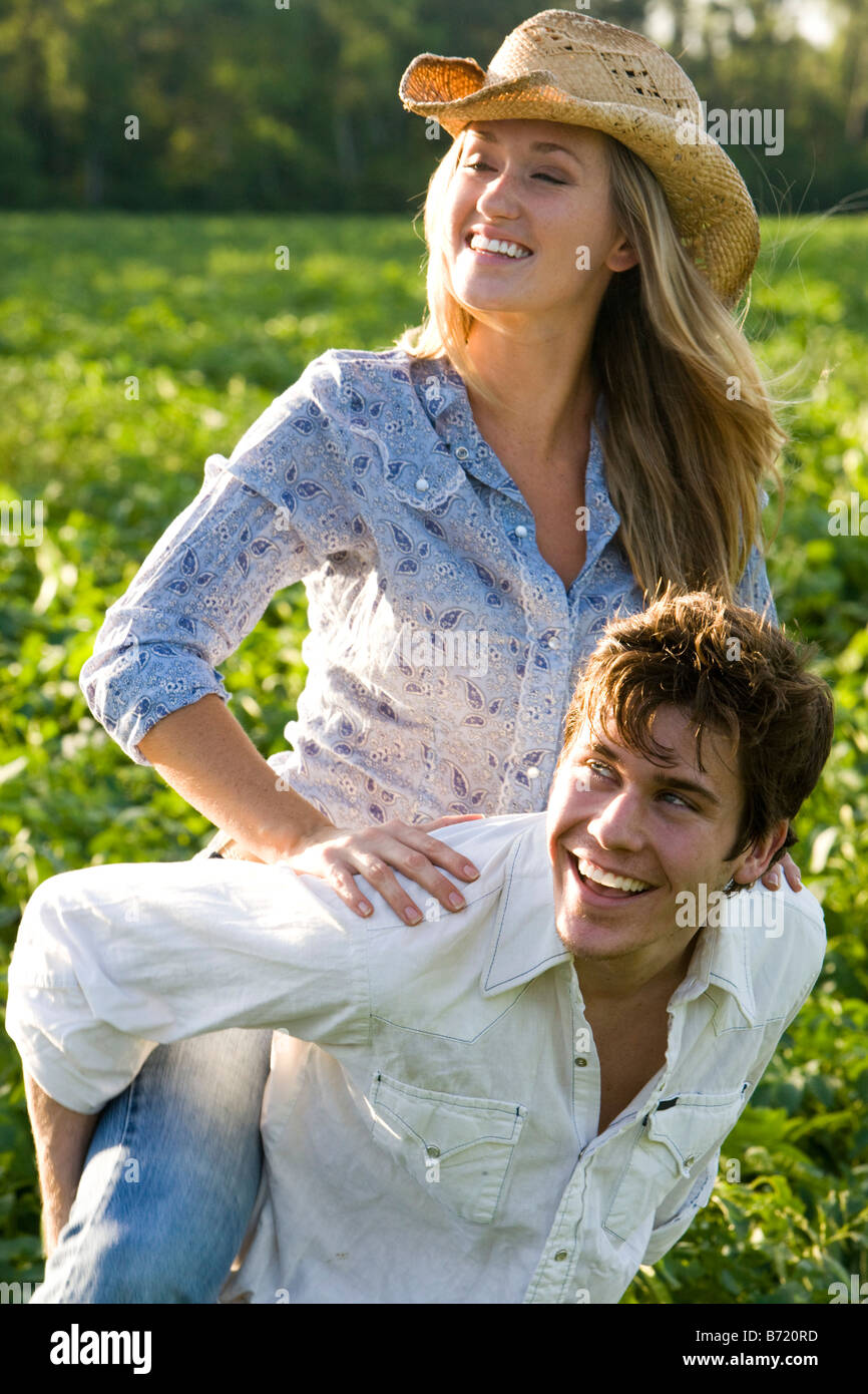 Young woman in cowboy hat on piggyback Stock Photo - Alamy