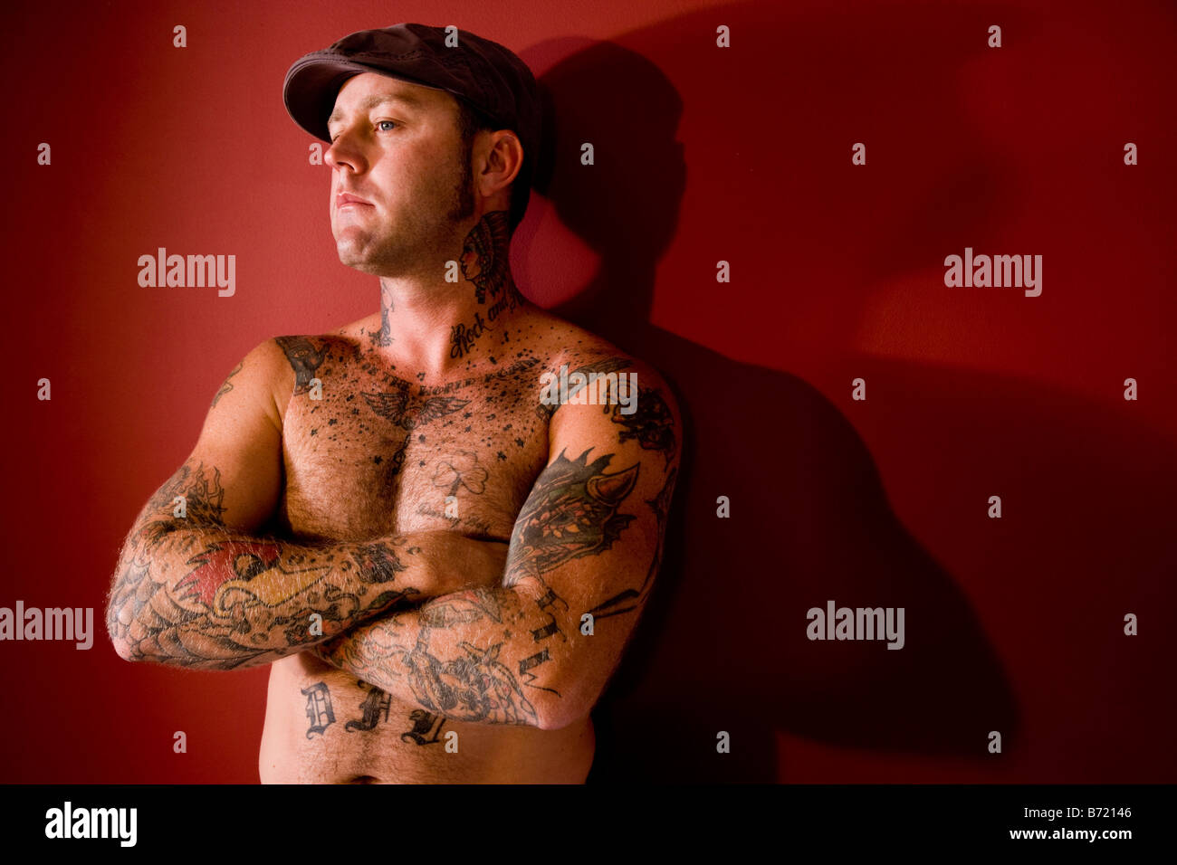 Young man with tattoo design on upper body Stock Photo - Alamy