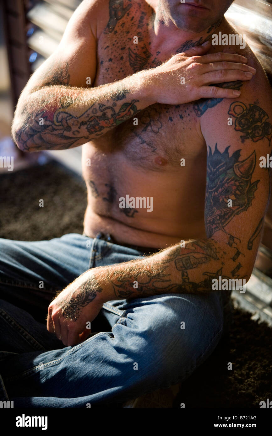 Young man with tattoo design on arms Stock Photo - Alamy
