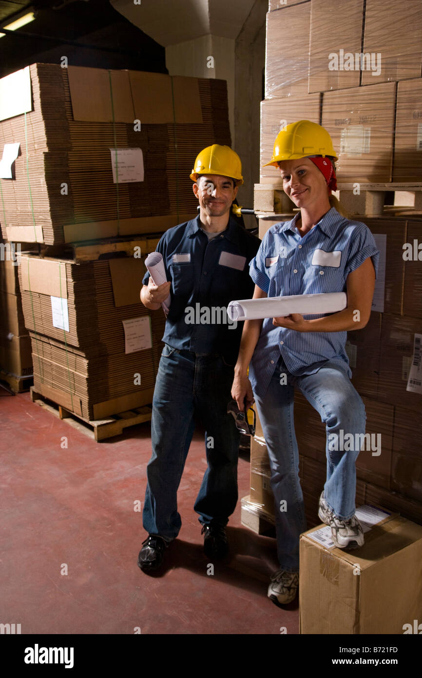 Two workers standing in storage warehouse Stock Photo - Alamy