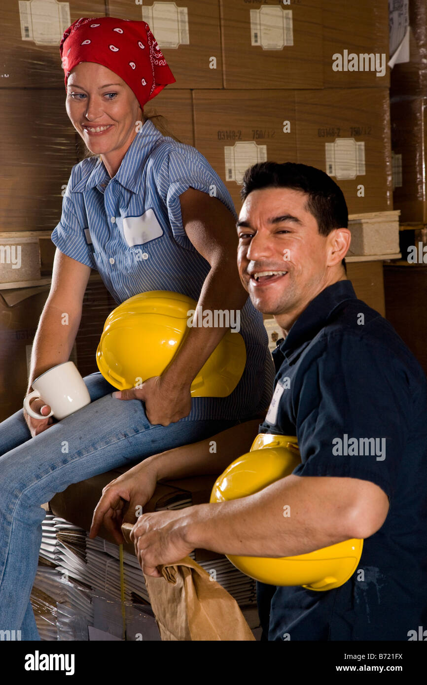 Two workers sitting in storage warehouse Stock Photo - Alamy