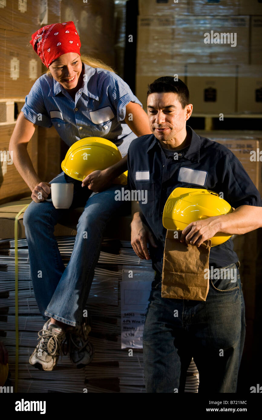 Two co-workers relax in storage warehouse Stock Photo - Alamy
