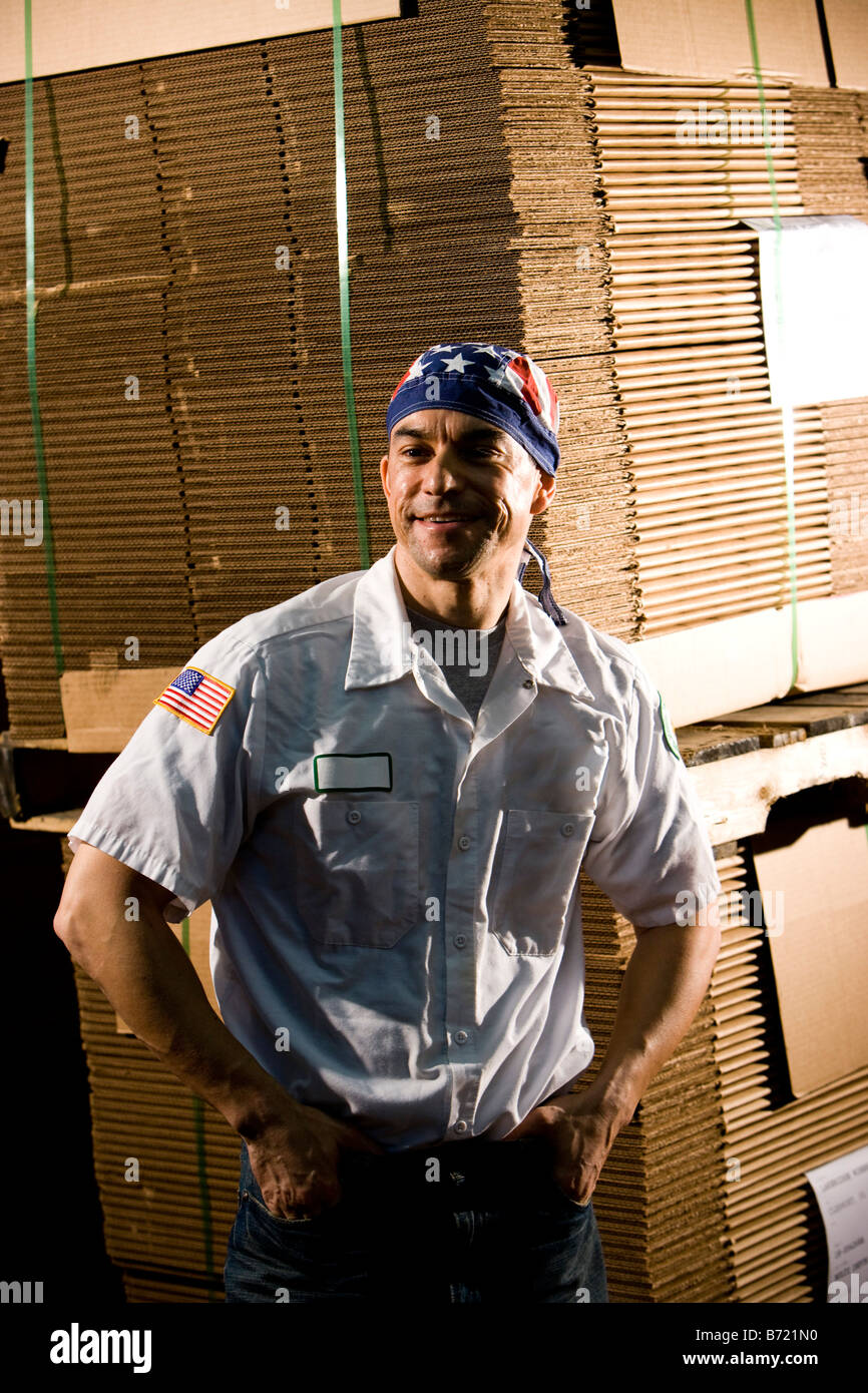 Mid adult man standing by boxes Stock Photo - Alamy