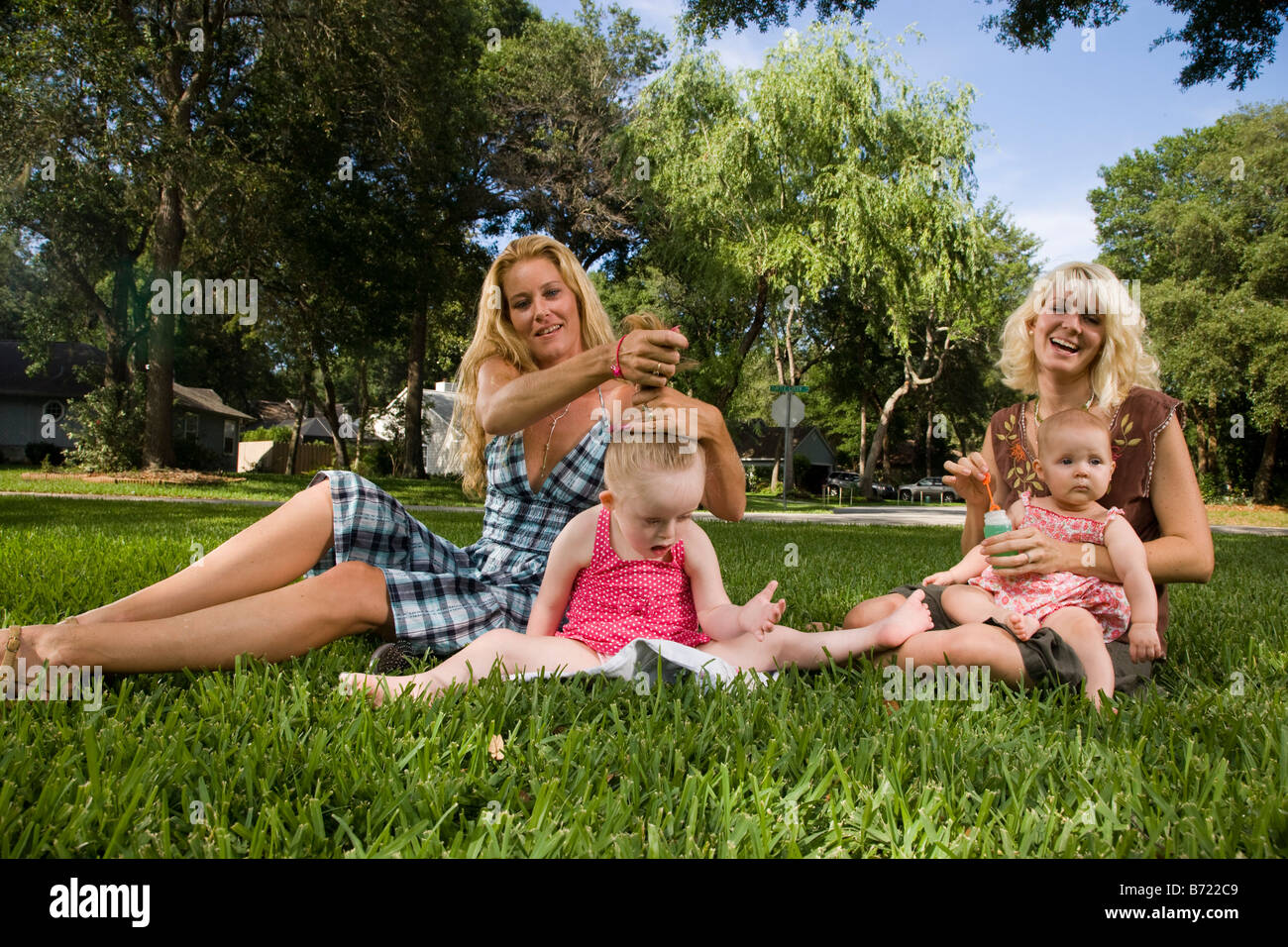 Mothers with baby on lap and young girl with downs syndrome Stock Photo ...