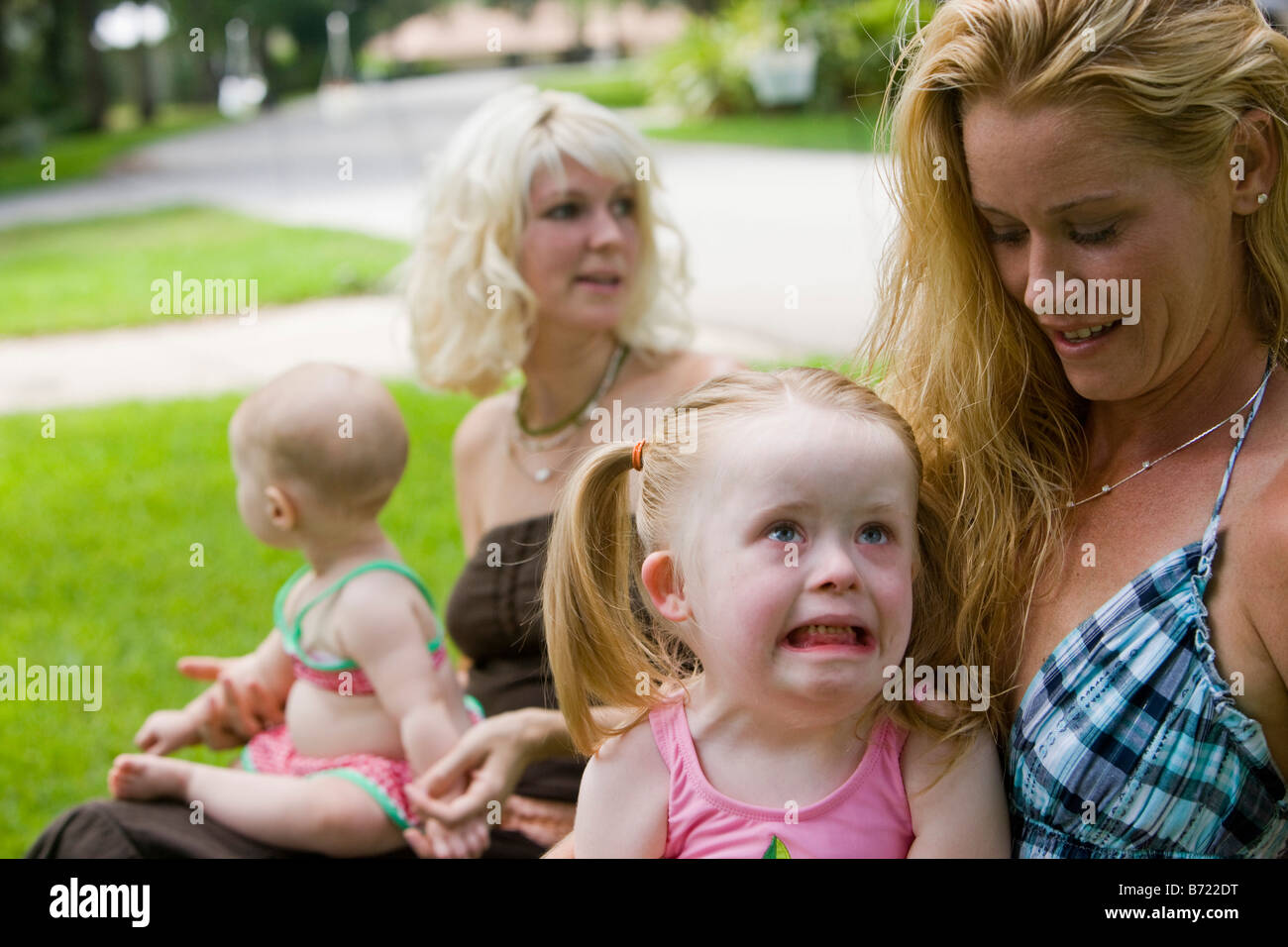 Girl with downs syndrome sitting on mother's lap Stock Photo - Alamy