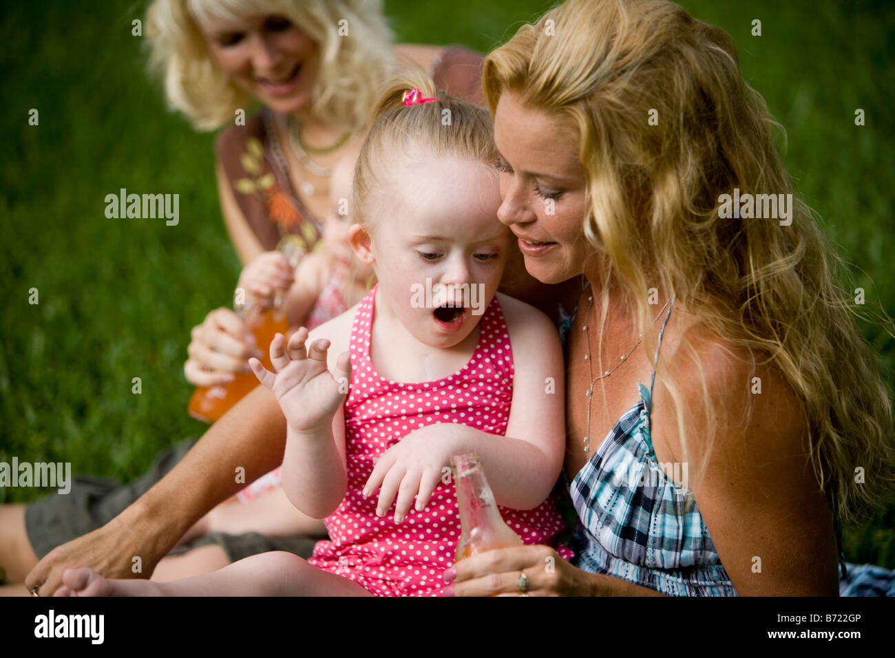Mother holding daughter with Down's Syndrome on lap Stock Photo - Alamy